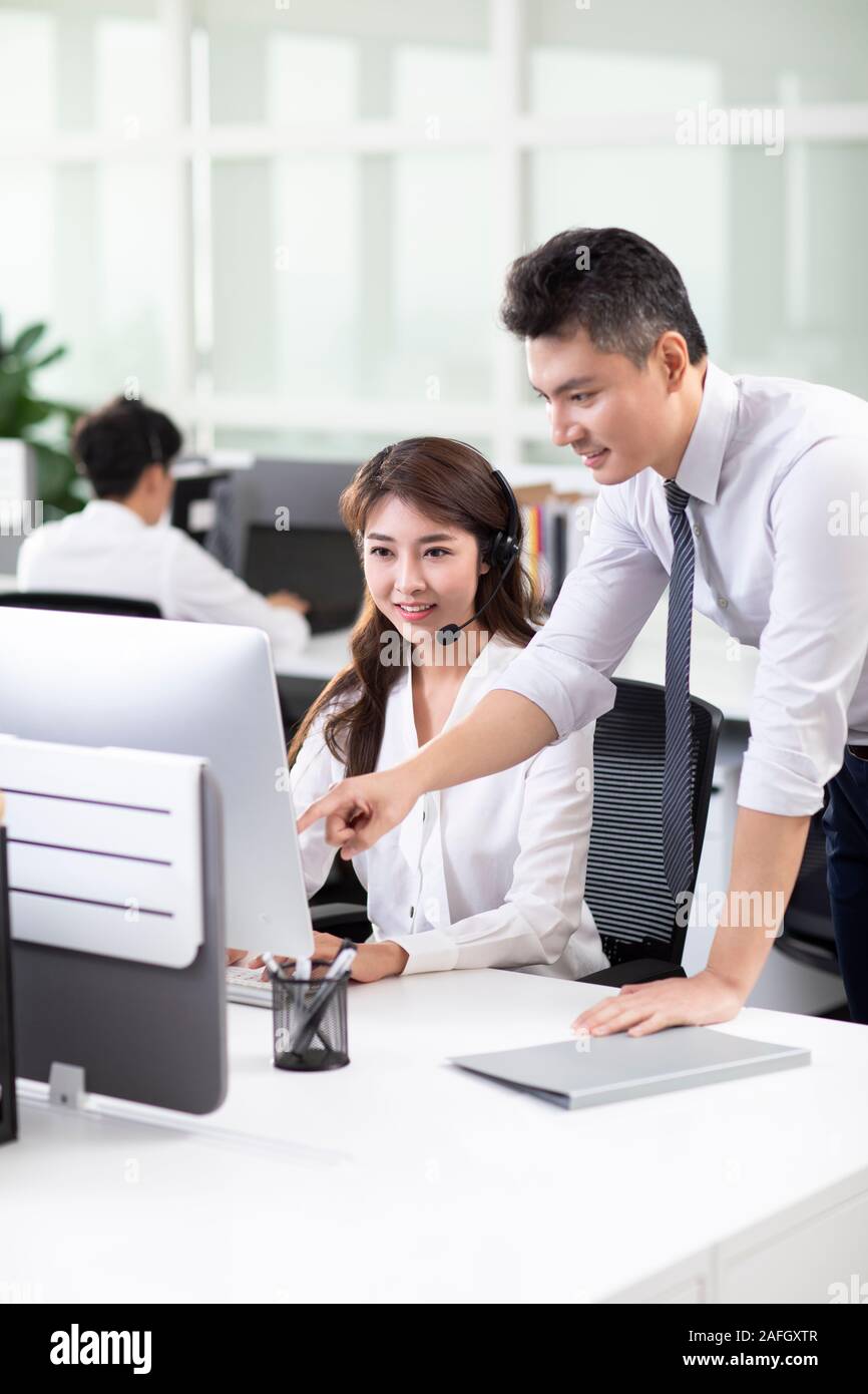 Call center agents working in office Stock Photo - Alamy