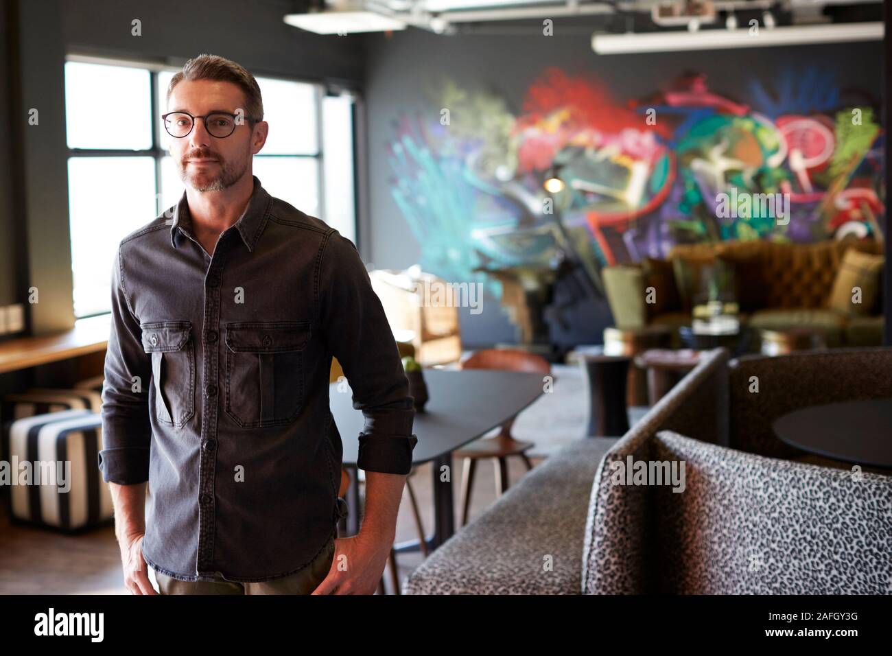 Man standing in cafe hi-res stock photography and images - Alamy