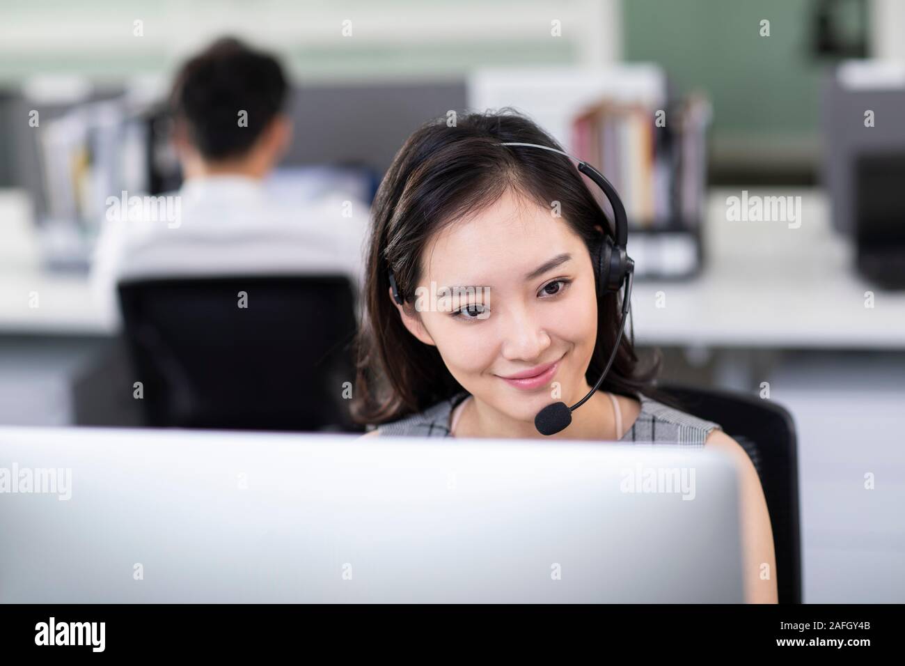 Young woman working in call center Stock Photo - Alamy