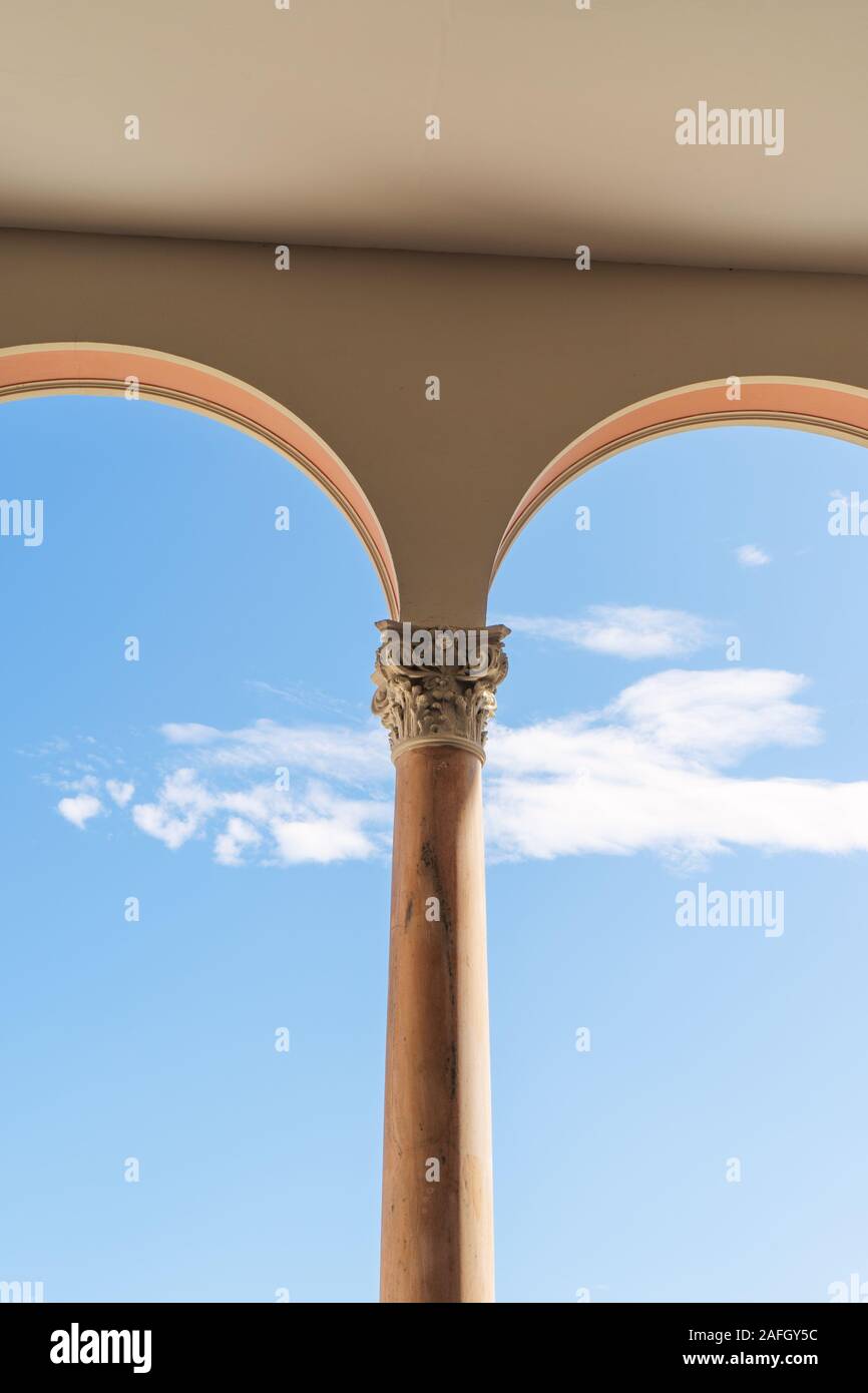 Vertical low angle shot of the column and the arch shaped ceiling of an ...