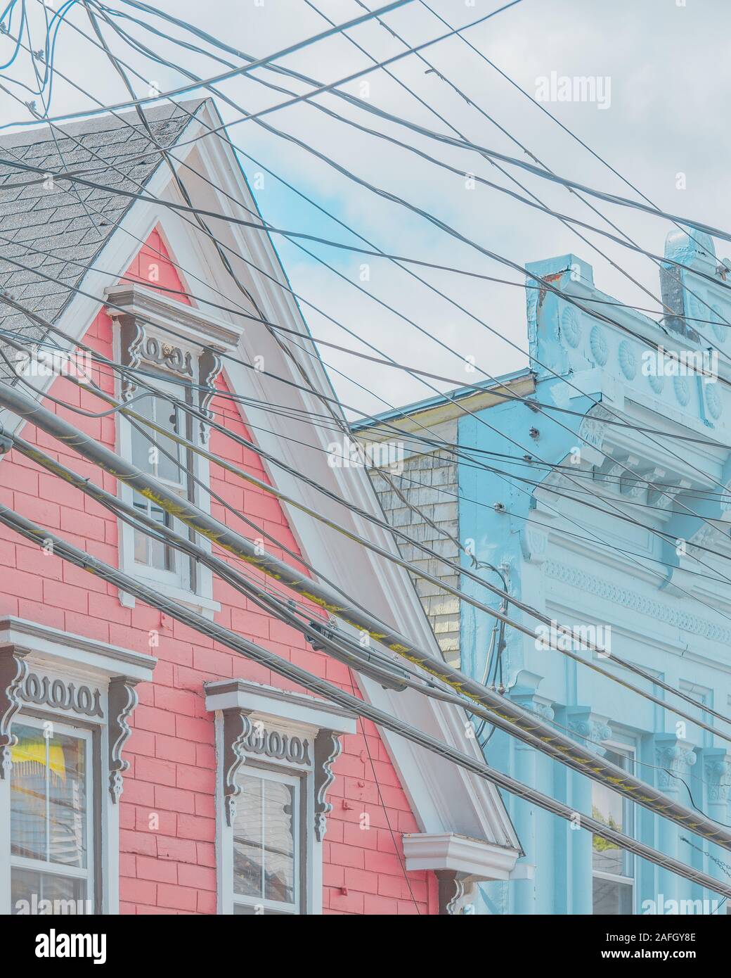 Vertical shot of a red building and a blue building behind the ...