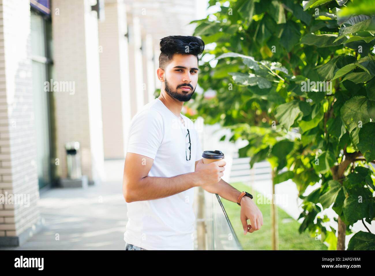travel, tourism and lifestyle concept - smiling indian man with ...
