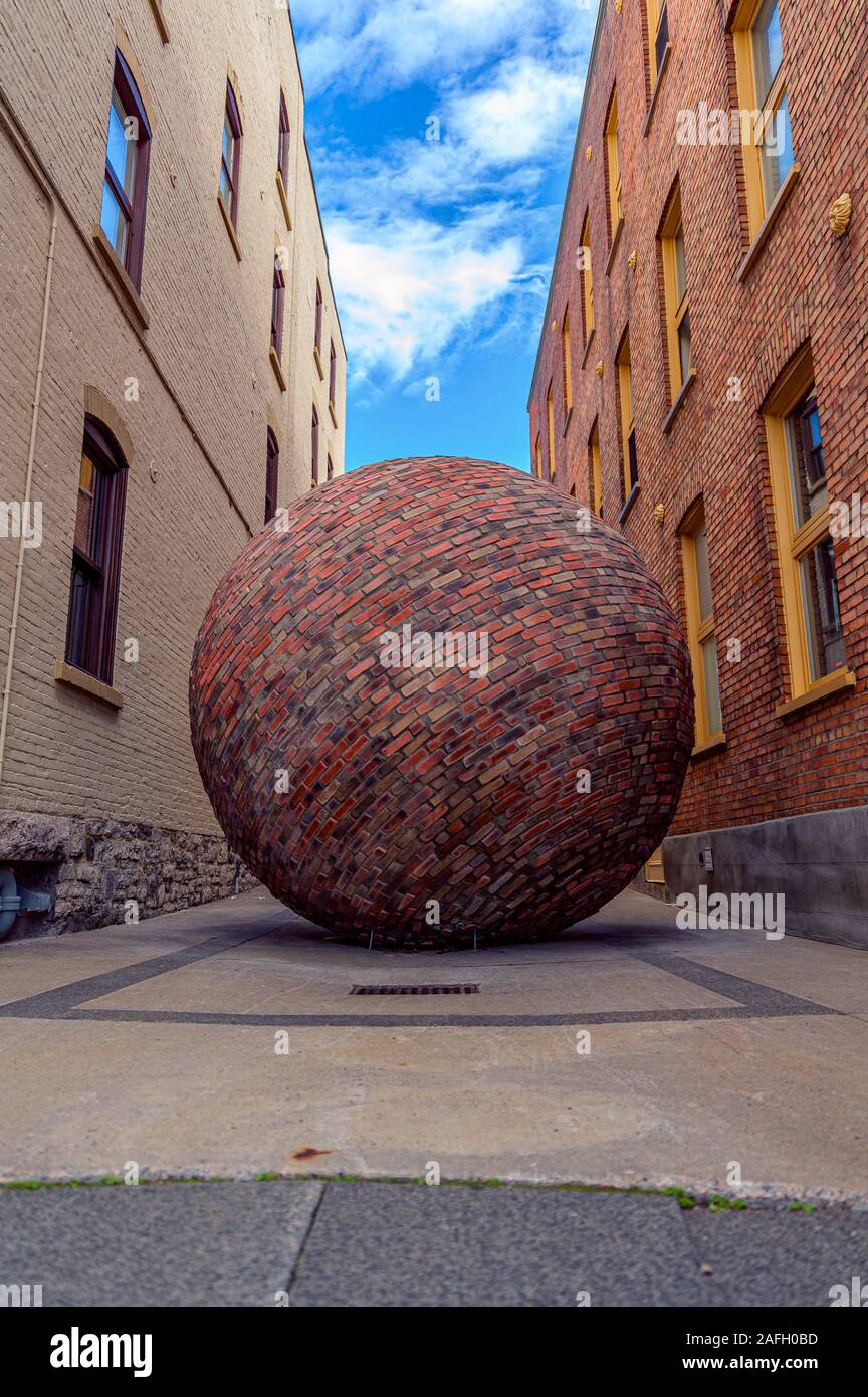 Vertical low angle shot of a huge round stone structure between two ...