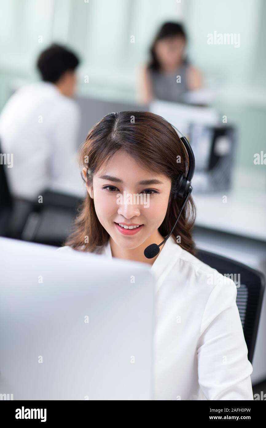 Young call center agents working in office Stock Photo - Alamy