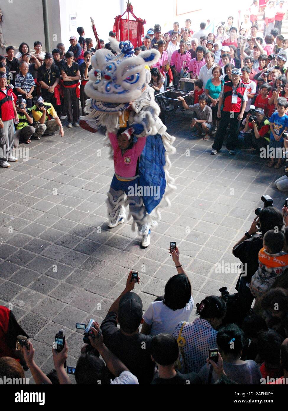 Lion dance puppet show and the crowd in Chinese New Year Festival Stock ...