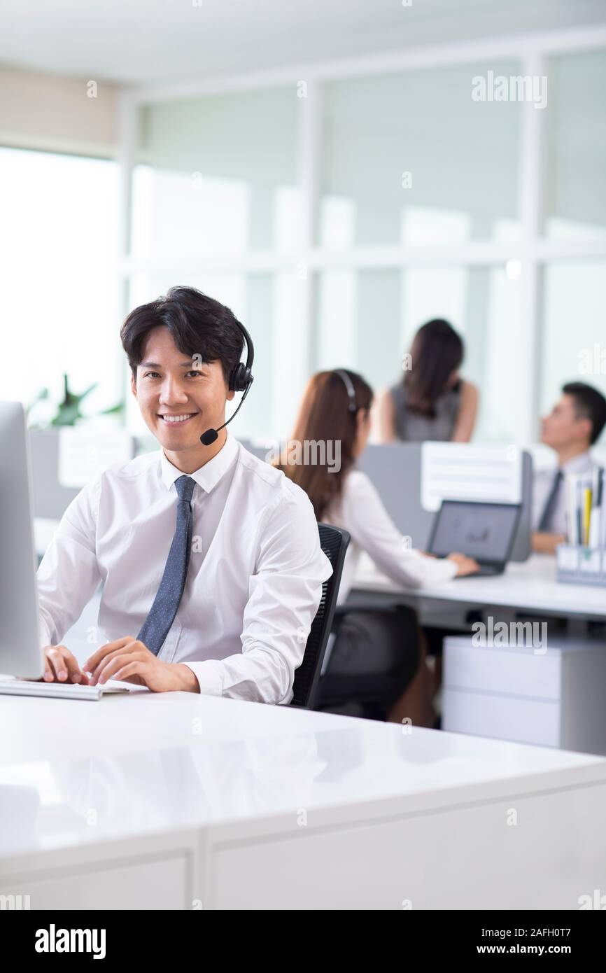 Call center agents working in office Stock Photo - Alamy