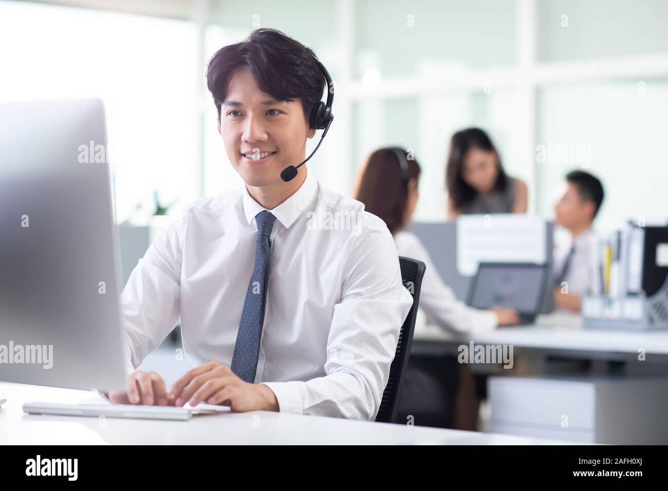 Call center agents working in office Stock Photo - Alamy