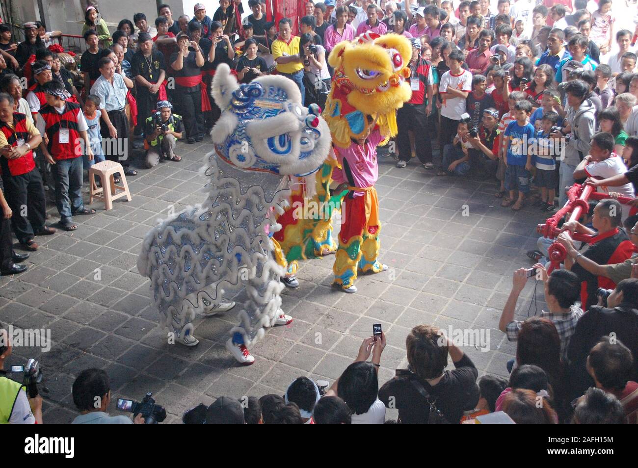 Lion dance puppet show and the crowd in Chinese New Year Festival Stock ...