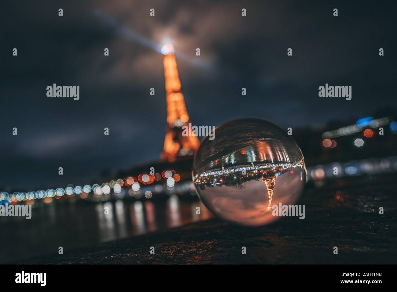 Famous historic Eiffel tower reflecting in a crustal ball during ...