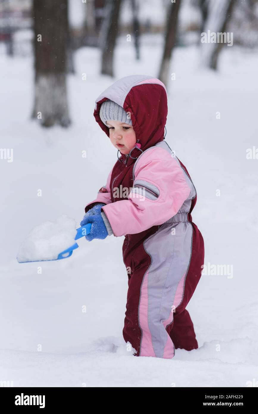 the child is digging the snow with a shovel Stock Photo - Alamy