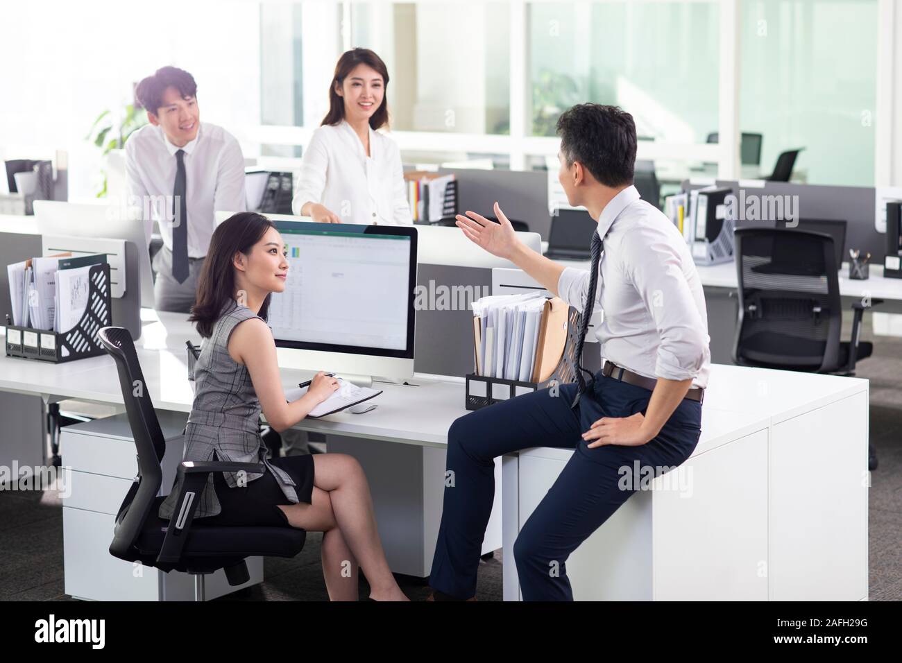 Successful business people talking in office Stock Photo - Alamy