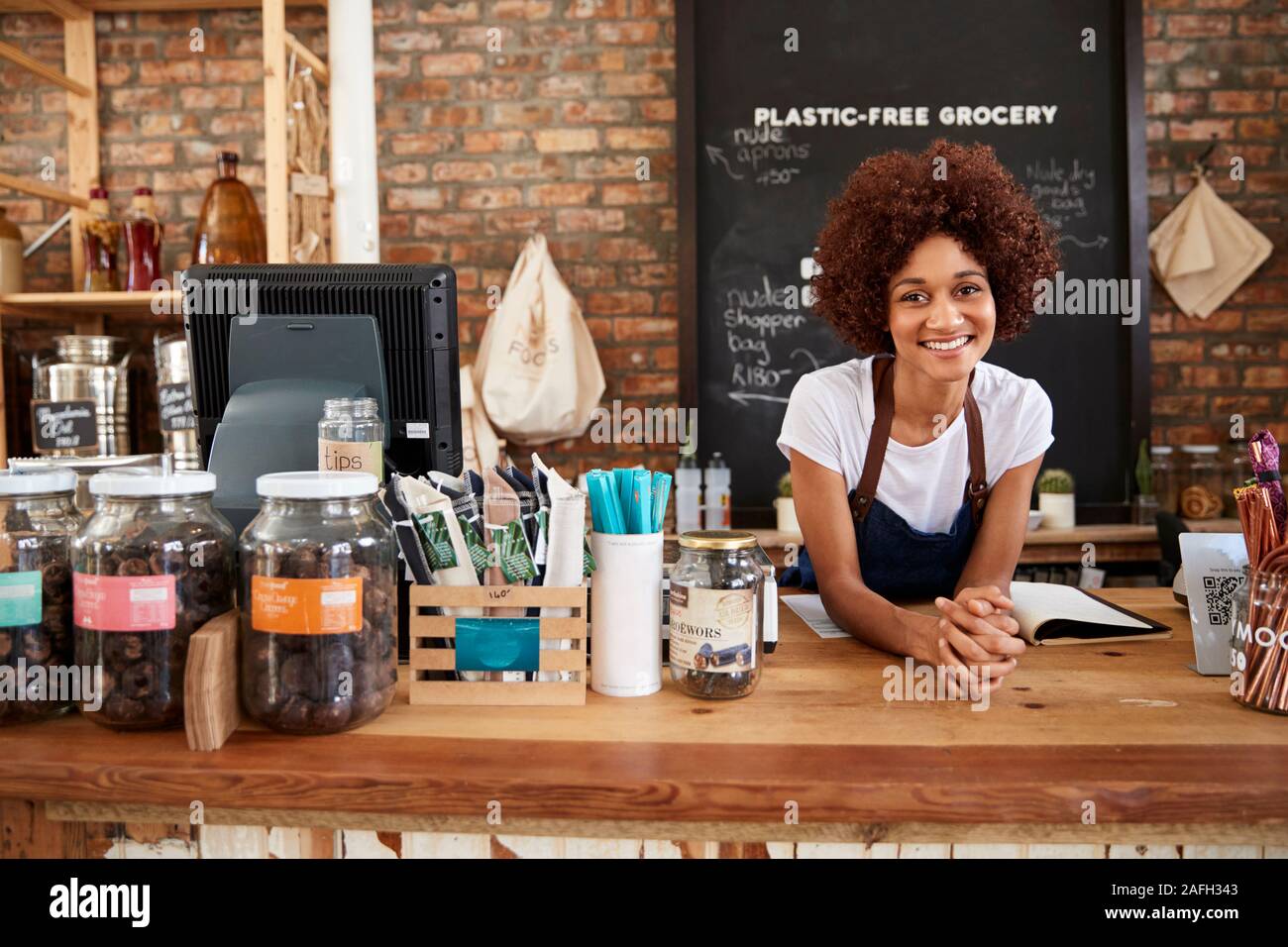 Portrait Of Female Owner Of Sustainable Plastic Free Grocery Store ...