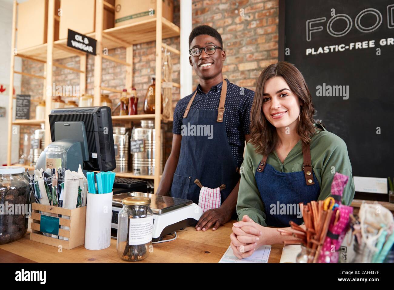 Portrait Of Male And Female Owners Of Sustainable Plastic Free Grocery ...