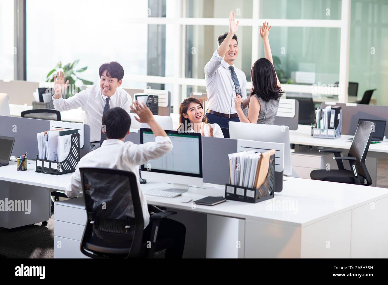 Business people celebrating success in office Stock Photo - Alamy