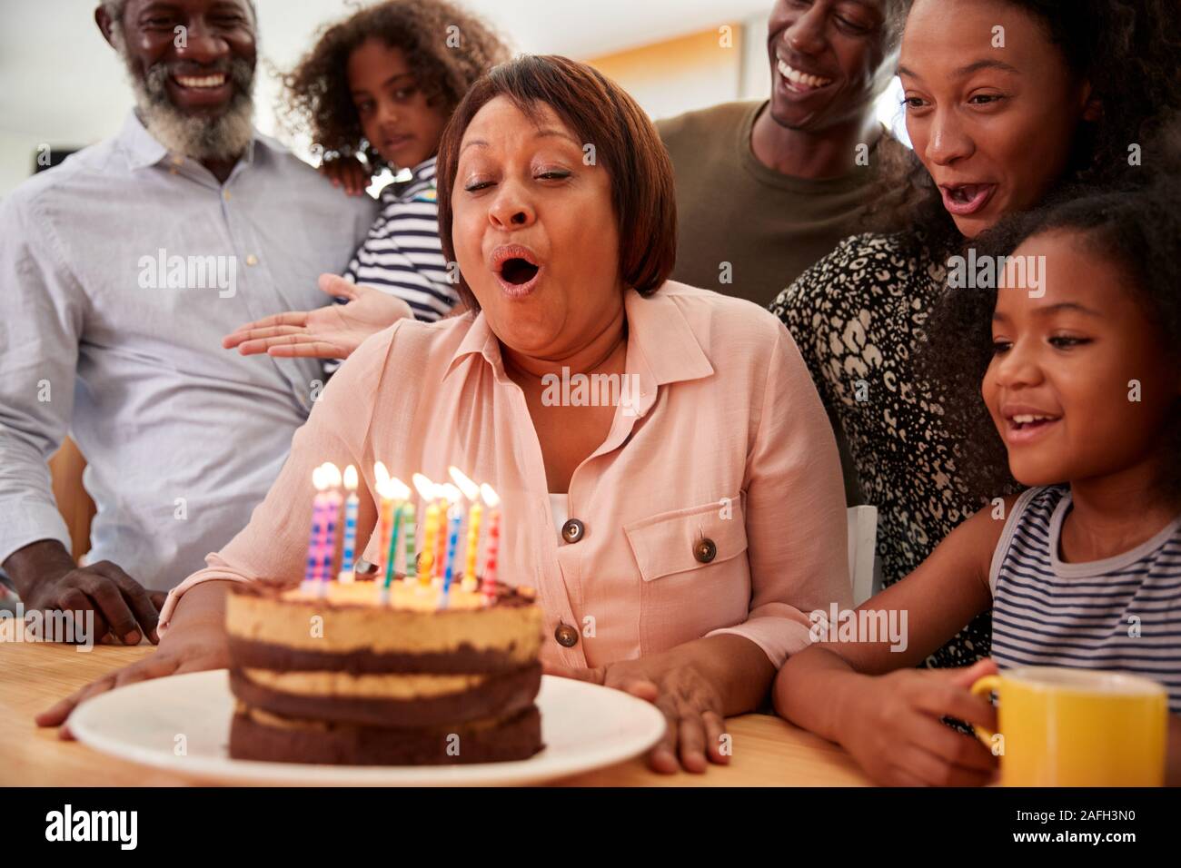 Blowing out birthday cake hi-res stock photography and images - Alamy