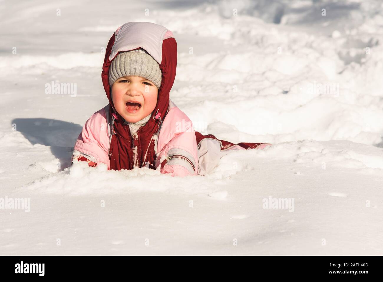 the child fell into the snow and cries Stock Photo - Alamy