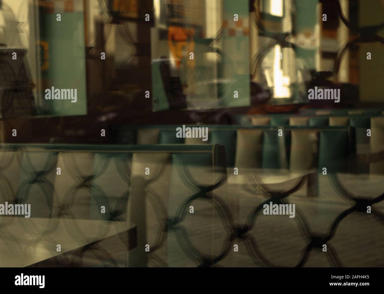 Inside of the restaurant captured from the outside of a glass window ...