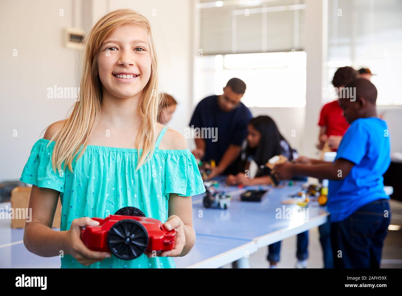 Portrait Of Female Student Building Robot Vehicle In After School Computer Coding Class Stock ...