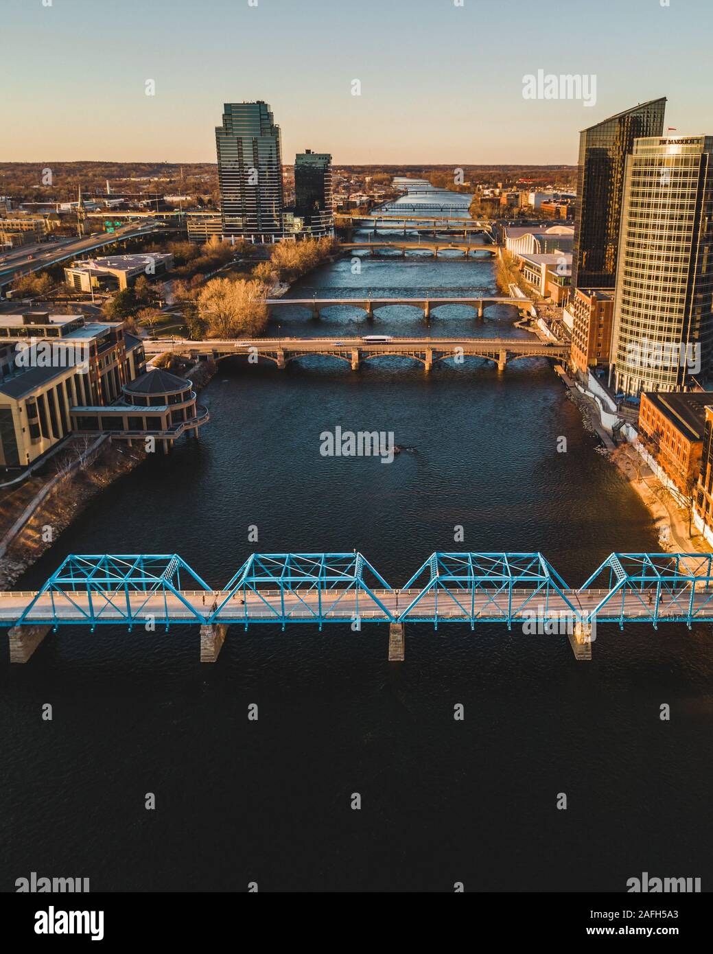 Vertical picture of a river with bridges on it surrounded by modern ...