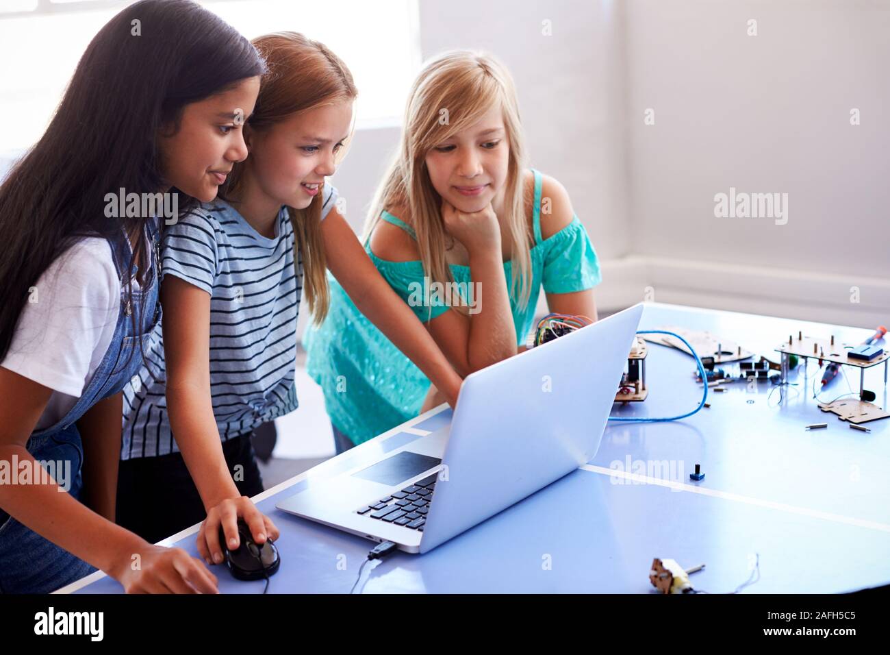 Three Female Students Building And Programing Robot Vehicle In After ...