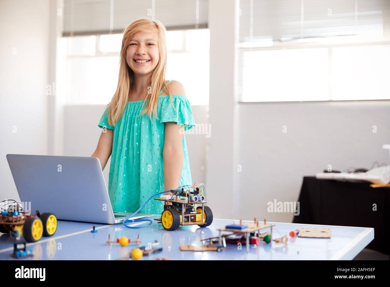 Portrait Of Female Student Building And Programing Robot Vehicle In ...