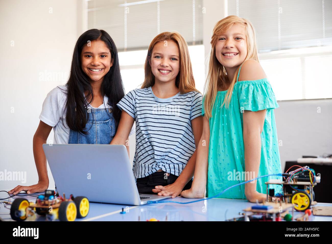 Portrait Of Three Female Students Building And Programing Robot Vehicle ...