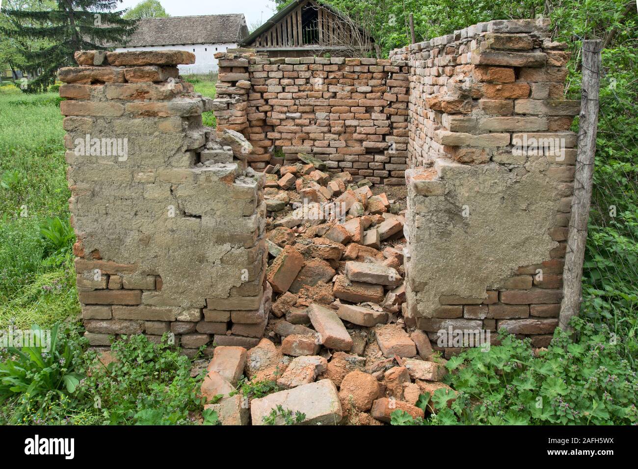 A pile of bricks from a collapsed wall and a few tiles Stock Photo - Alamy