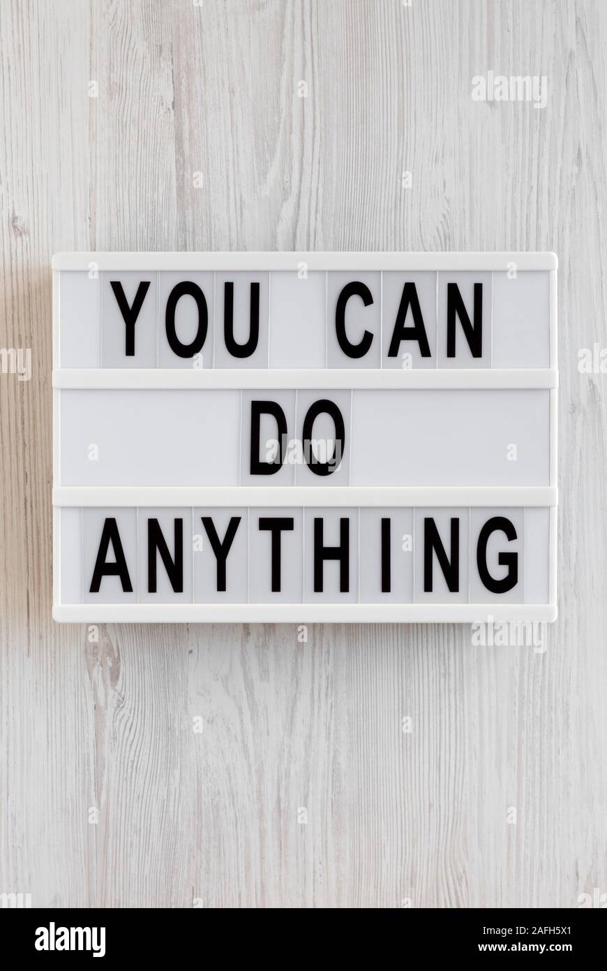 'You can do anything' words on a modern board on a white wooden ...