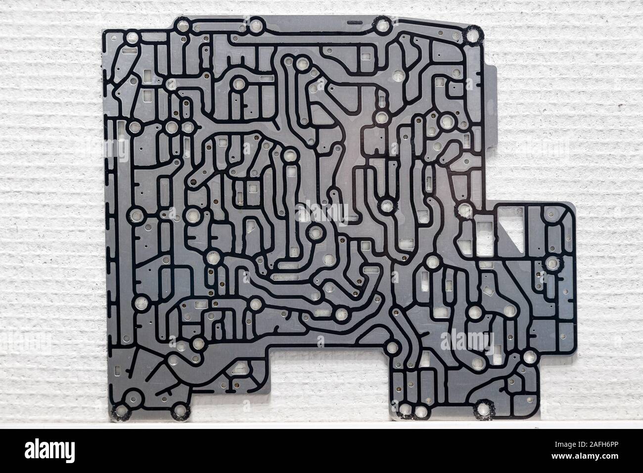 An electronic microcircuit with an aluminum board with black tracks for ...