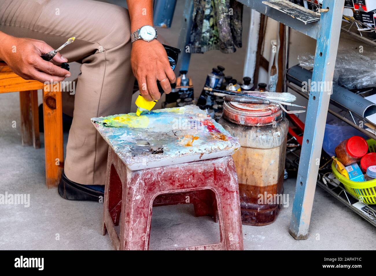 A Vietnamese artist mixing paint on canvas Stock Photo - Alamy