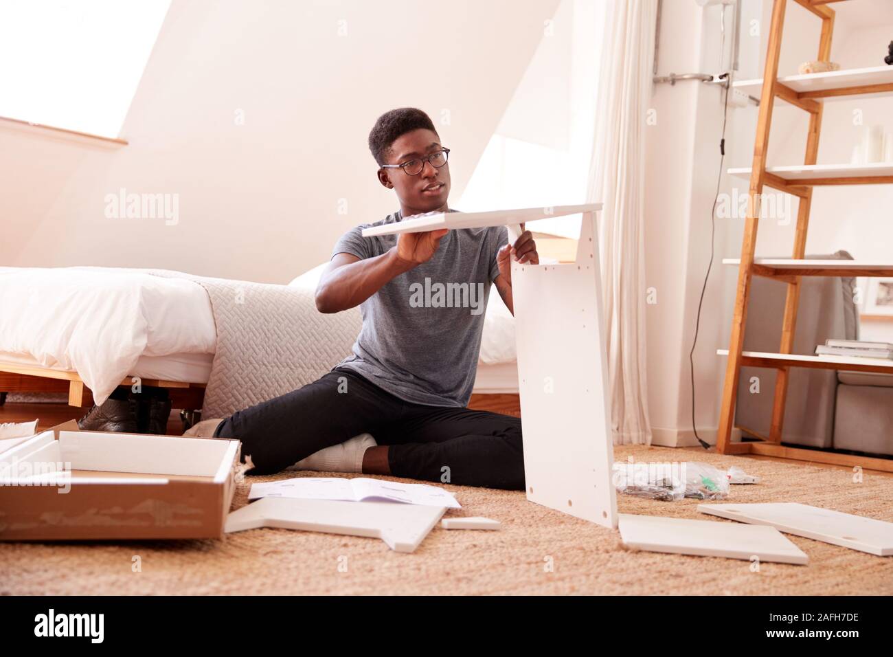 Man In New Home Putting Together Self Assembly Furniture Stock Photo ...