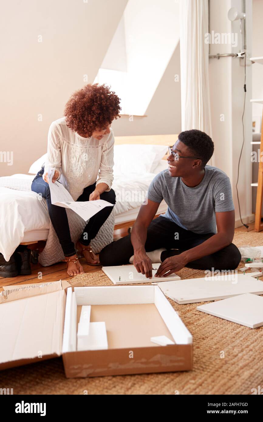 Couple In New Home Putting Together Self Assembly Furniture Stock Photo ...