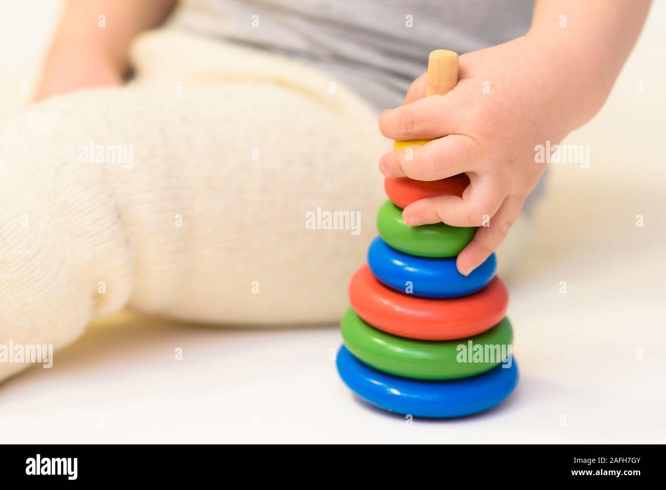 child plays with a pyramid in the room Stock Photo - Alamy