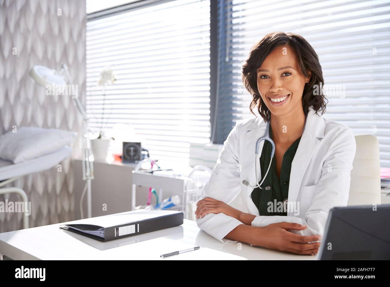 Portrait Of Smiling Female Doctor Wearing White Coat With Stethoscope ...