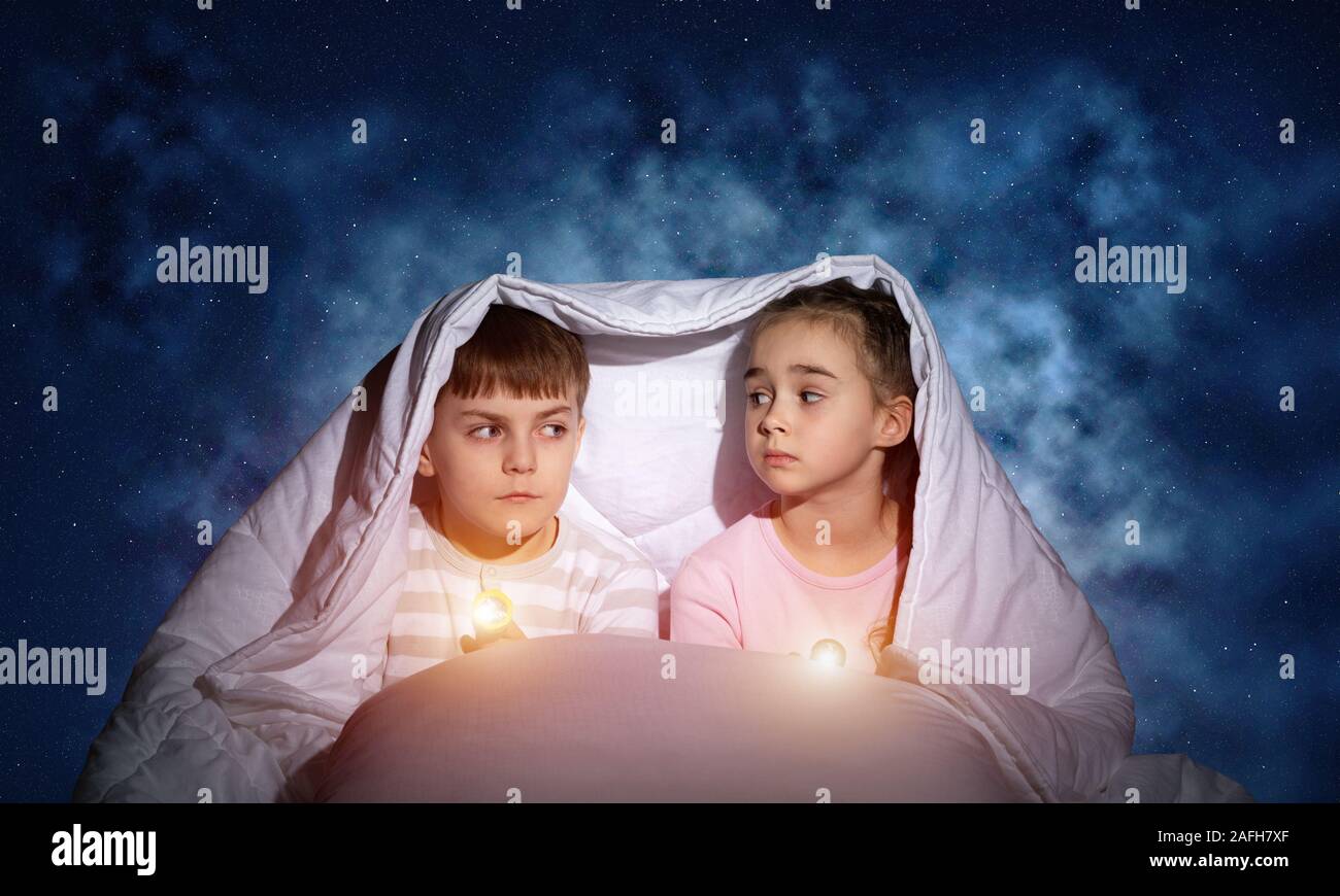 Children with flashlights in bed Stock Photo - Alamy