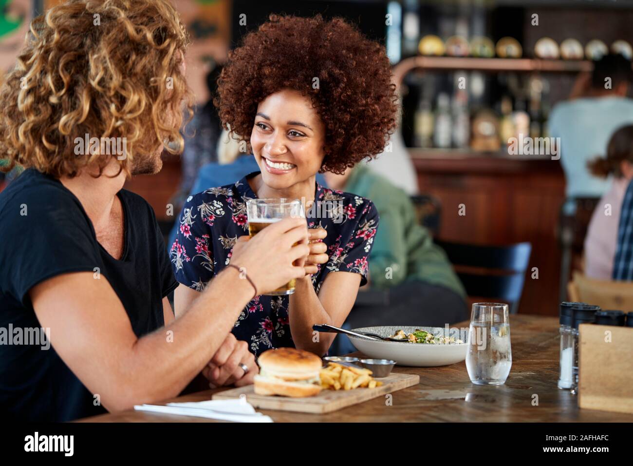 Romantic couple eating burger hi-res stock photography and images - Alamy