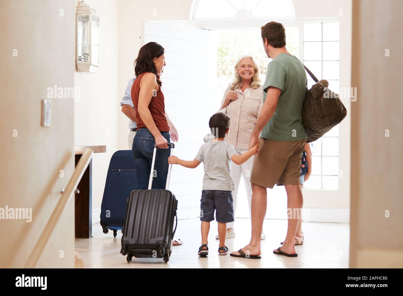 Three generation white family leaving their home to go on holiday, full ...