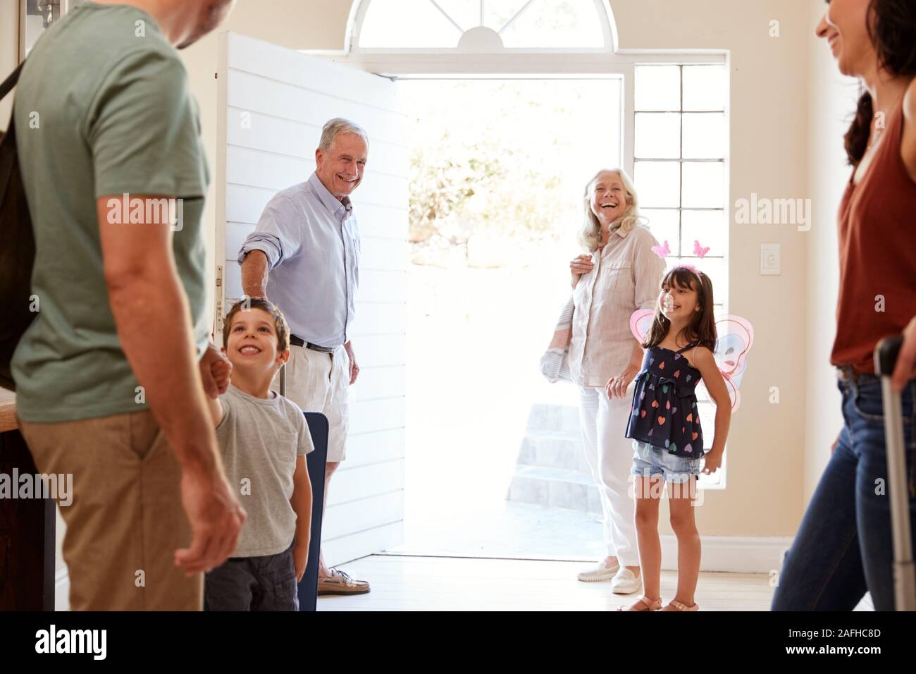 Three generation white family leaving their home to go on holiday ...