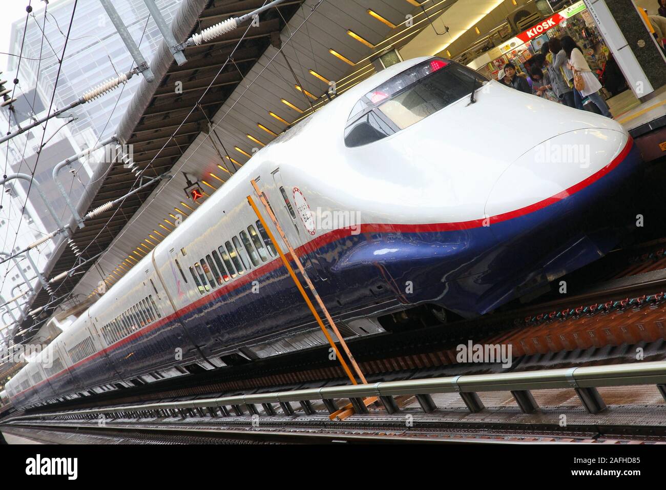 TOKYO, JAPAN - MAY 4, 2012: Travelers board Shinkansen Hayate train at ...