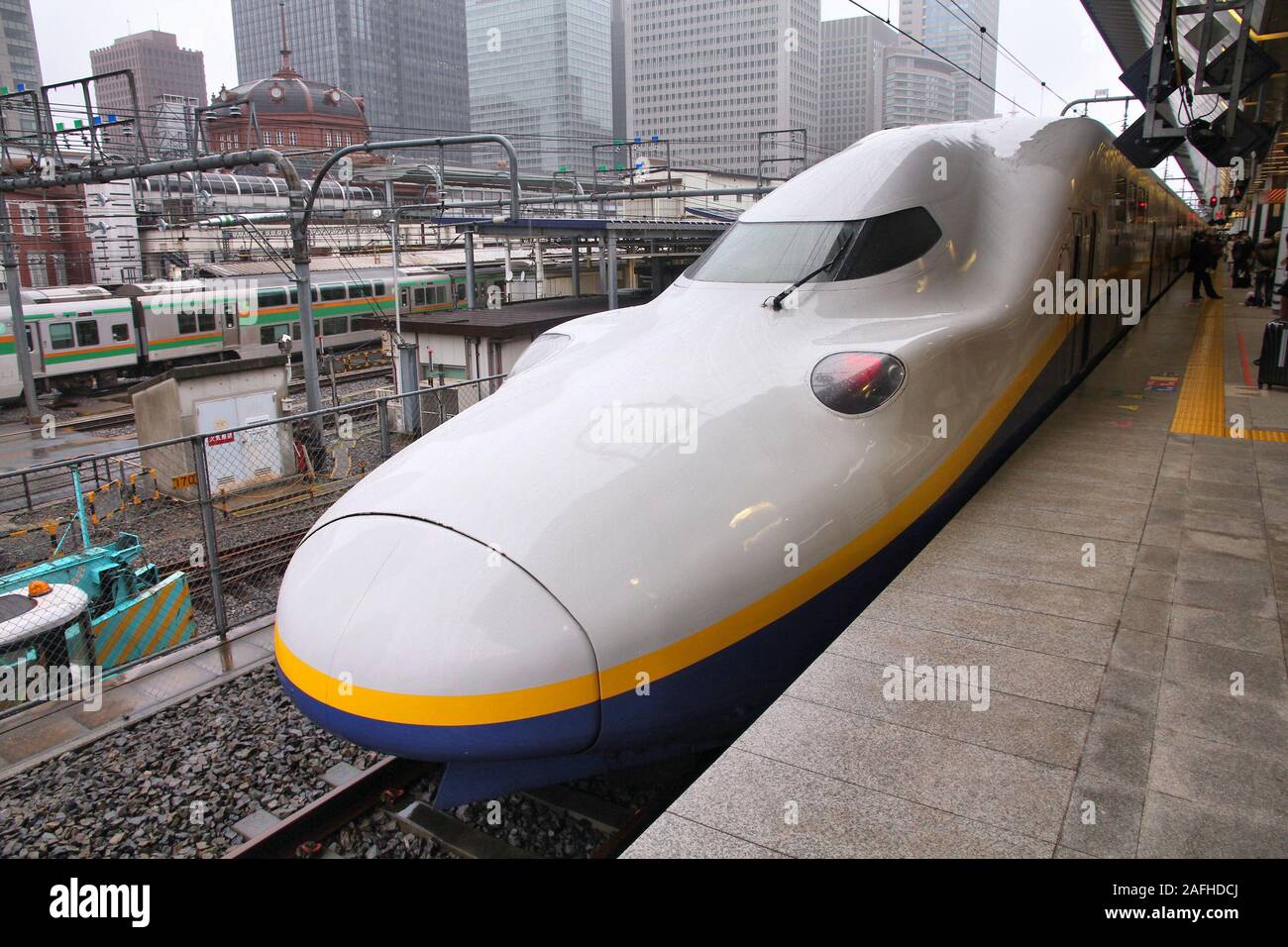 TOKYO, JAPAN - MAY 4, 2012: Travelers board Tohoku Shinkansen E4 series ...