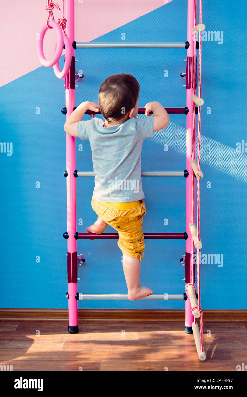 little kid climbs the stairs in the gym Stock Photo - Alamy