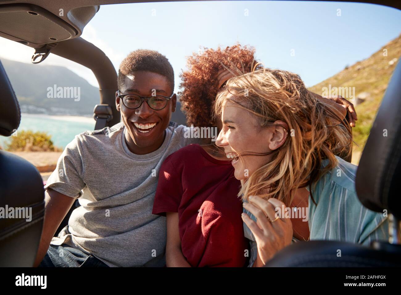 Three friends laughing in car hi-res stock photography and images - Alamy