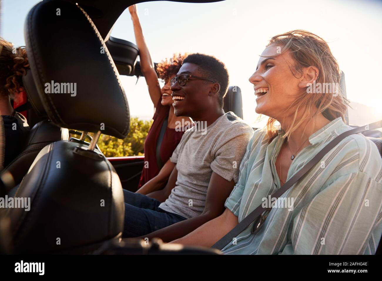 Three friends laughing in car hi-res stock photography and images - Alamy