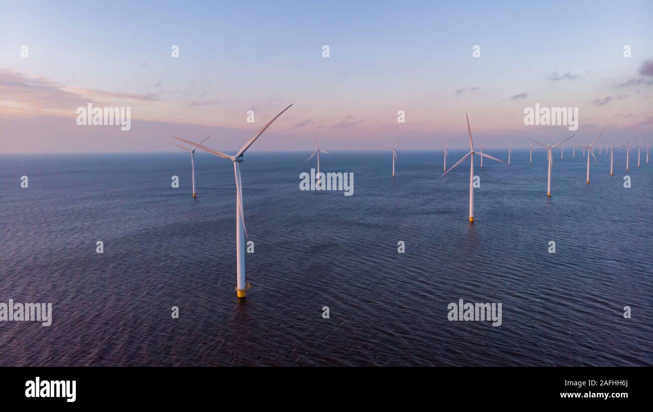 Windmill park green energy during sunset in the ocean, offshore wind ...