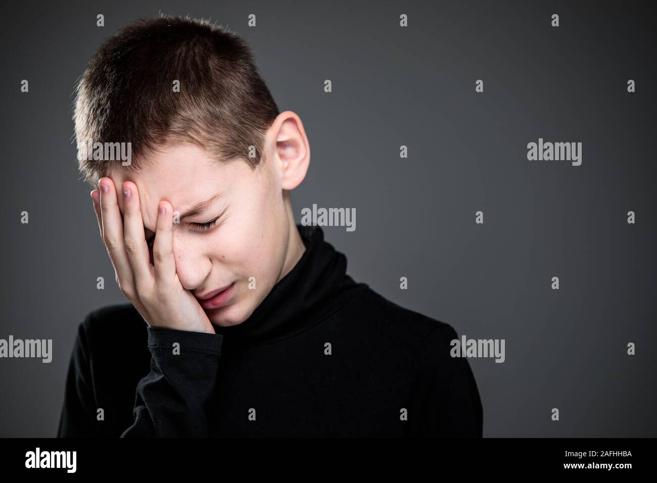 Grief-stricken little boy - feeling intense sorrow, remorse, sadnesss ...