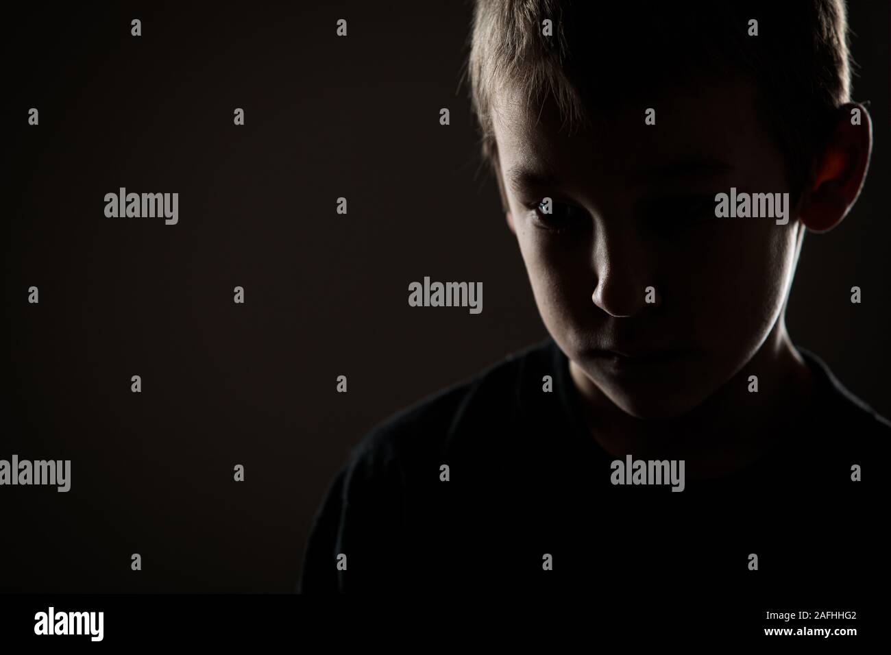 Grief-stricken little boy - feeling intense sorrow, remorse, sadnesss ...