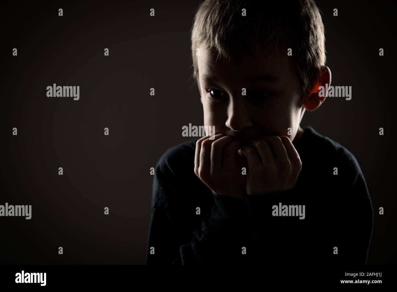 Grief-stricken little boy - feeling intense sorrow, remorse, sadnesss ...