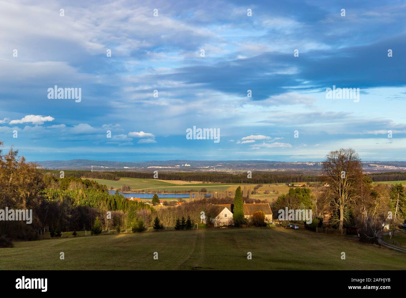 Landscape of South Bohemia with villages, forests, fields and blue sky ...