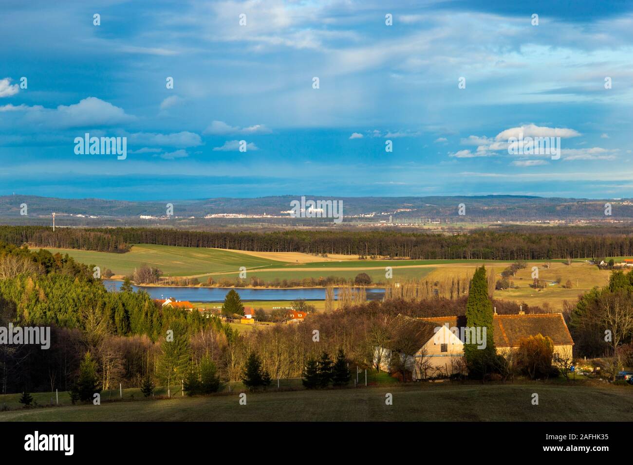 Landscape of South Bohemia with villages, forests, fields and blue sky ...