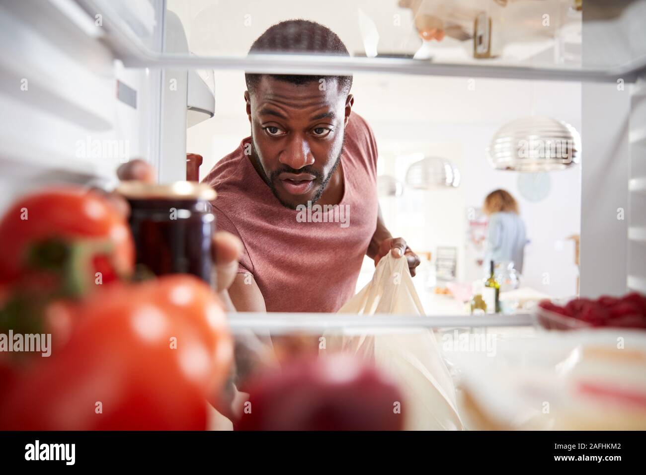 View Looking Out From Inside Of Refrigerator As Man Opens Door And ...
